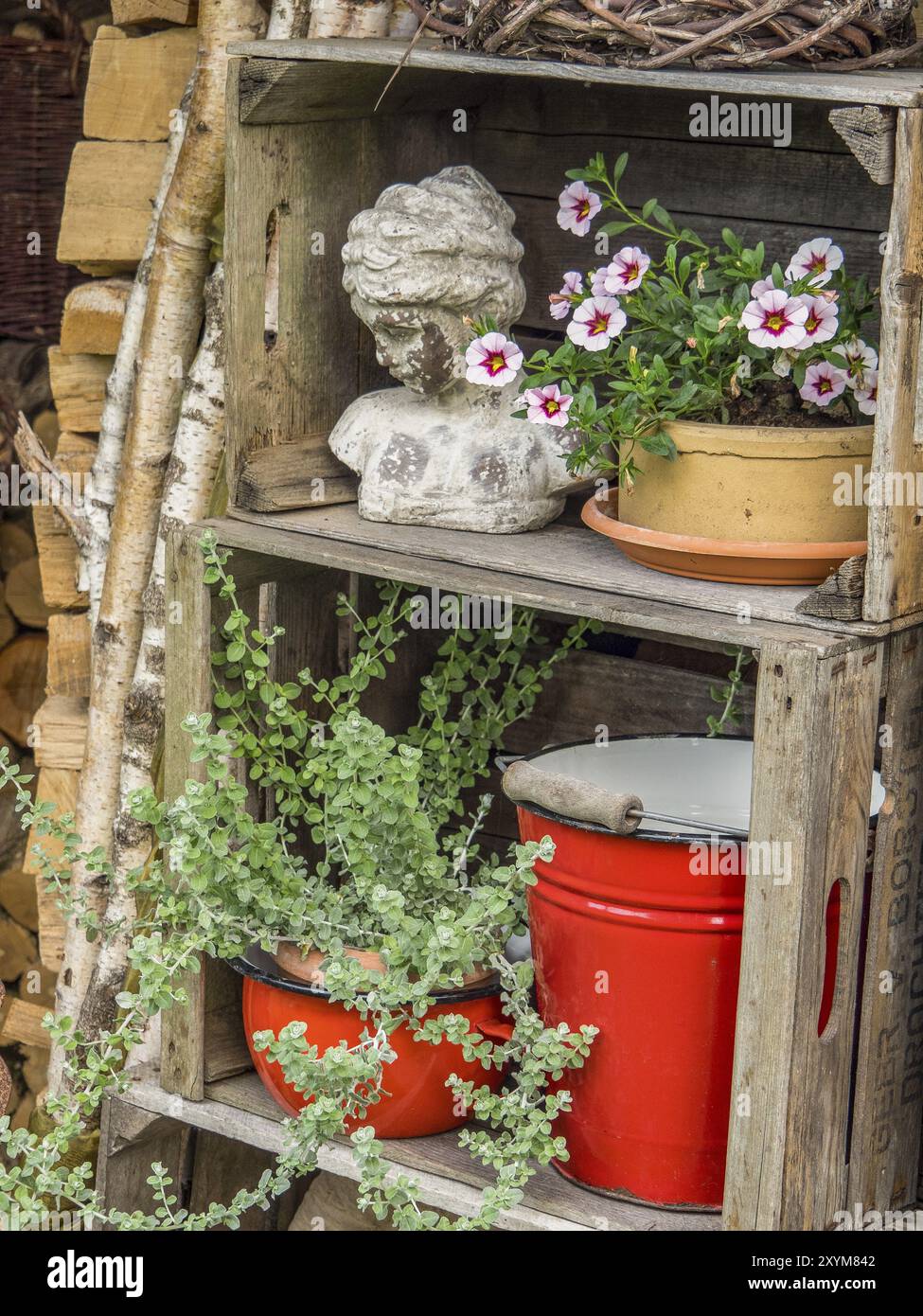 Rustic garden decor on a shelf with bust, flower pots and plenty of ...