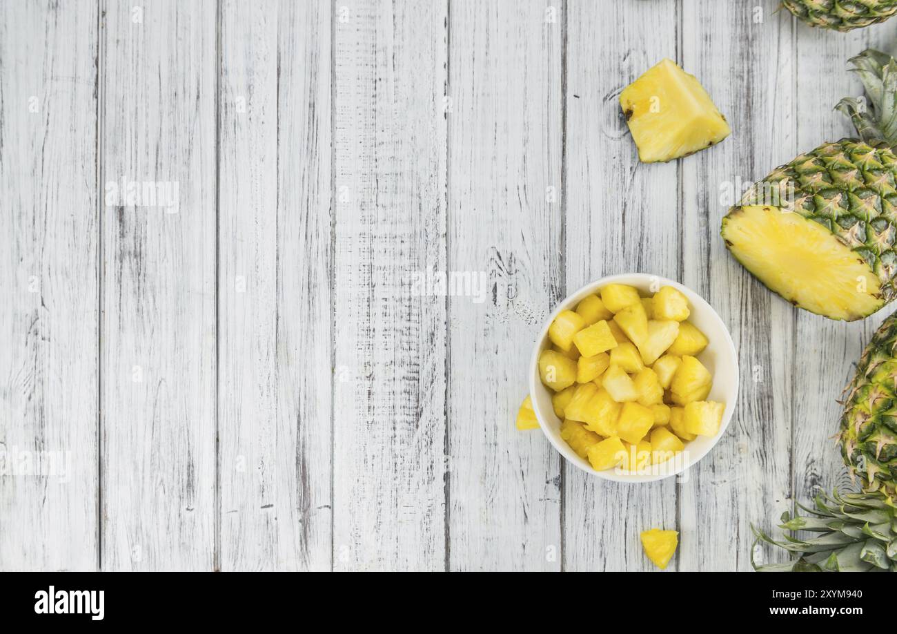 Fresh made Pineapple (sliced) on a vintage background as detailed close ...