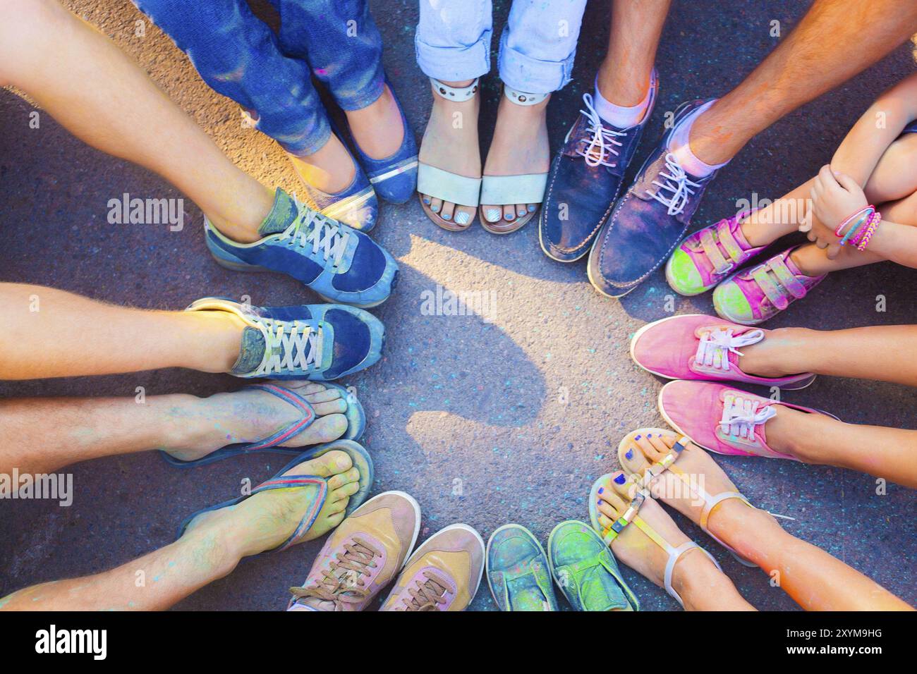 Friends putting their feet together in a sign of unity and teamwork ...