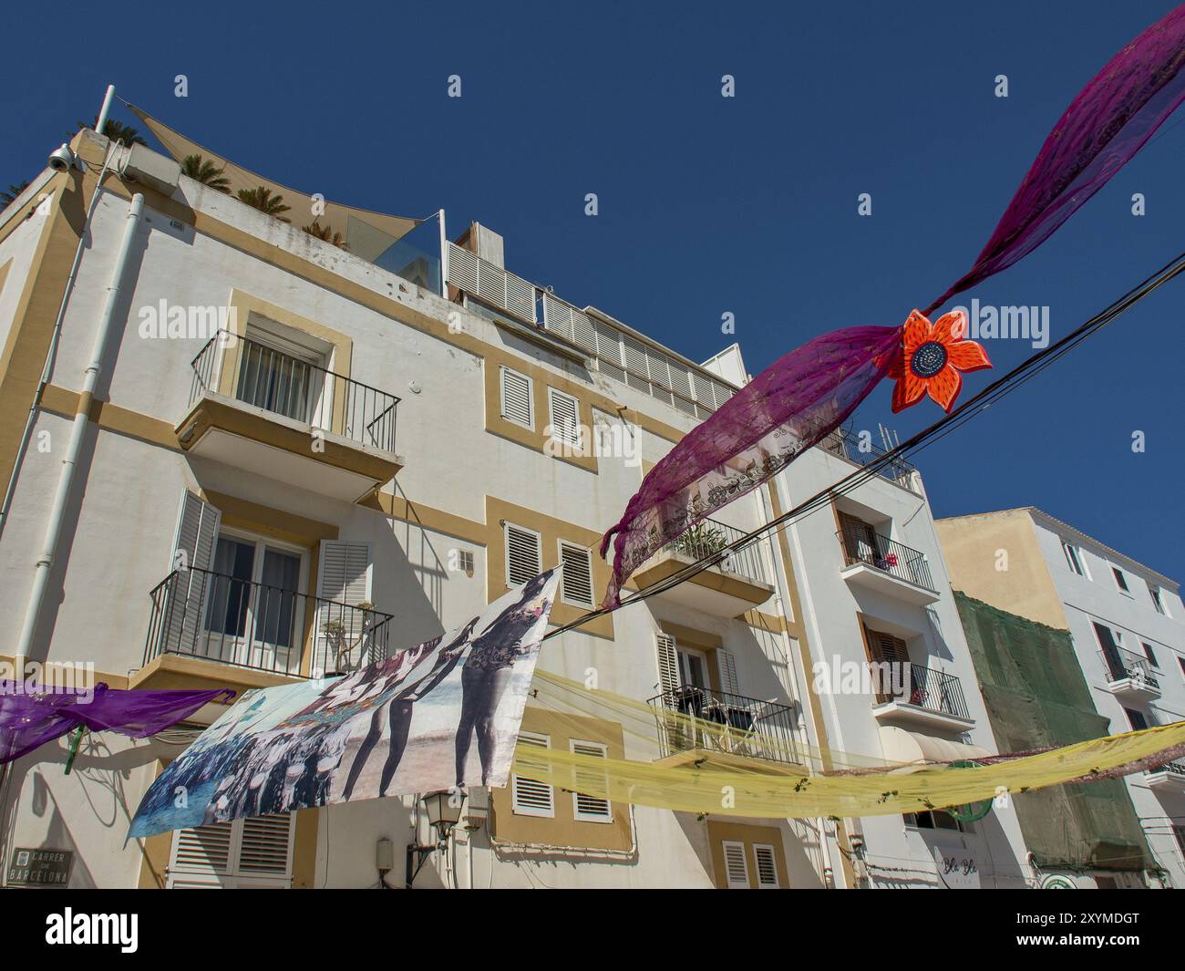 Imaginatively decorated street scene with fabric banners and balconies ...