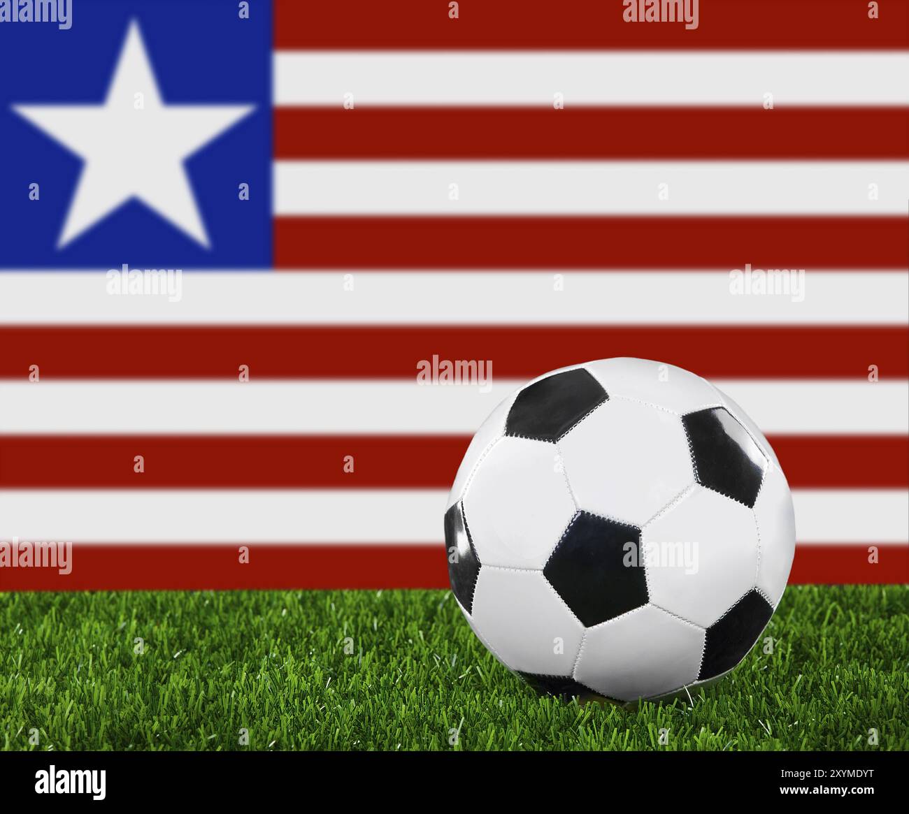 The Liberian flag and soccer ball on the green grass Stock Photo - Alamy