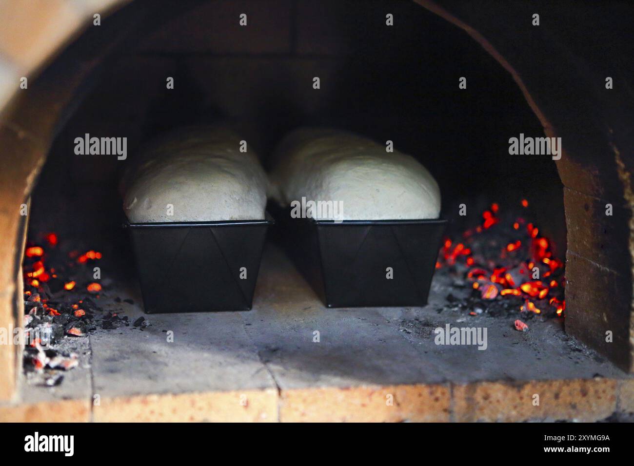 Two handmade breads being cooked in traditional bread oven Stock Photo ...