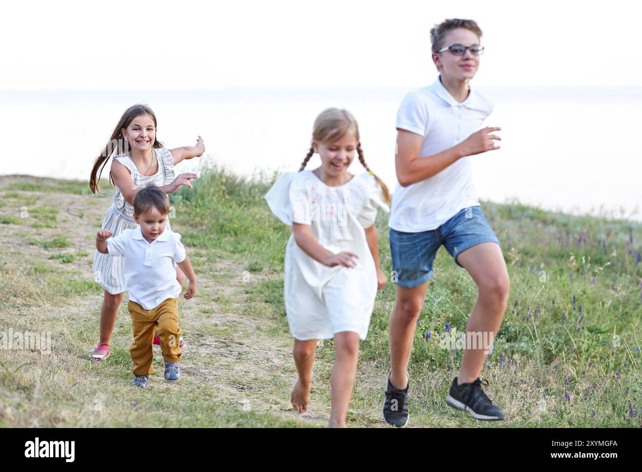 Kids playing and running in the summer park Stock Photo - Alamy