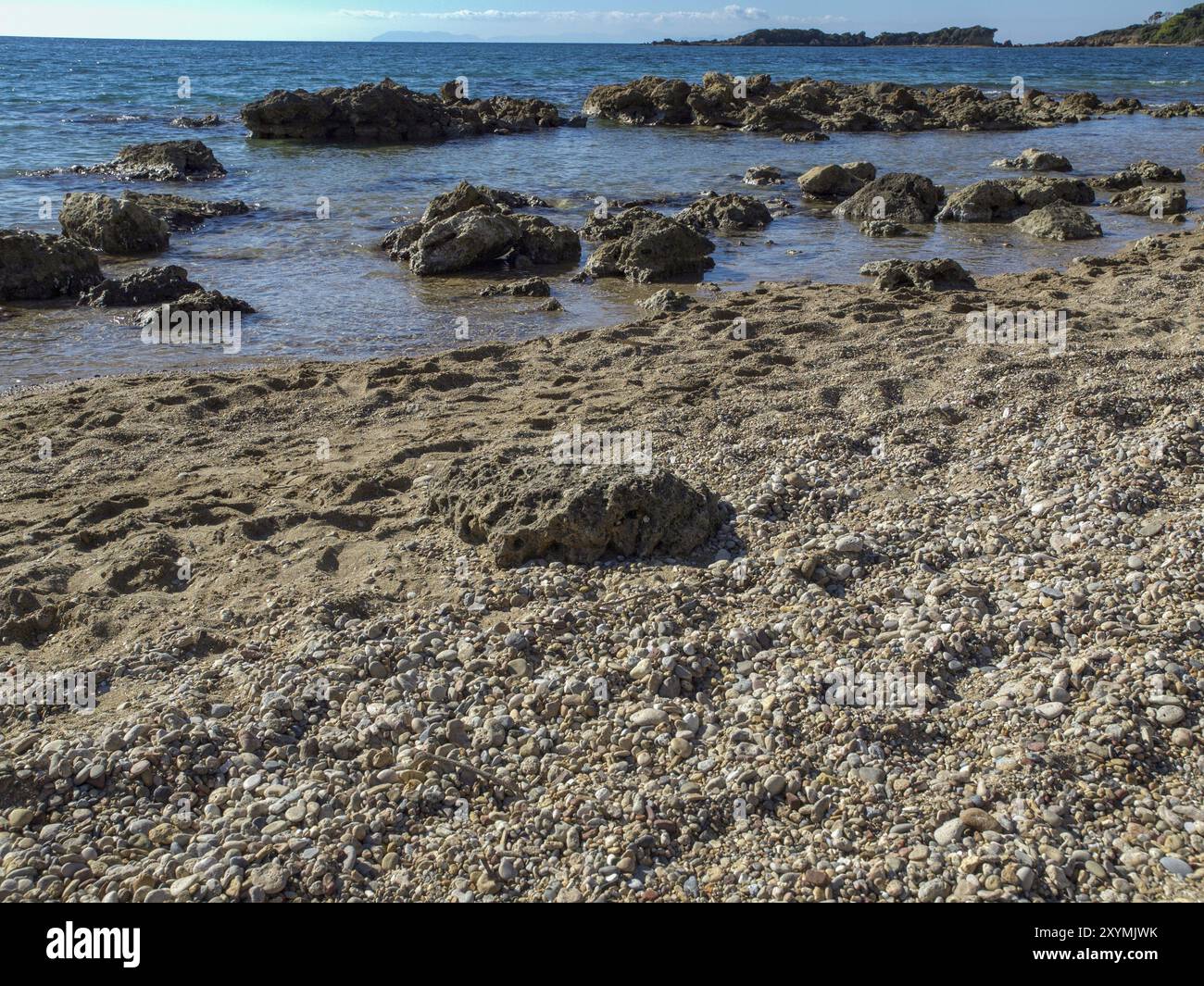 Pebble beach with rocks and sea waves, katakolon, mediterranean sea ...