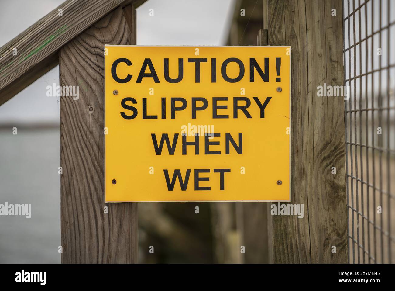 Sign: Caution! Slippery when wet, seen in Amble in Northumberland ...