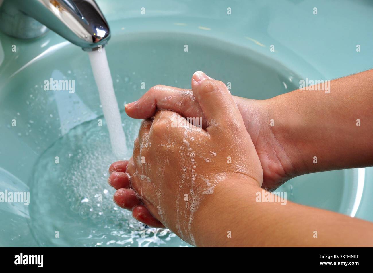 Hands being washed in a green sink Stock Photo - Alamy