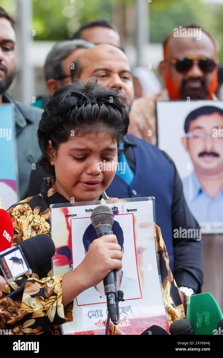 People hold pictures of family members who went missing, during an ...