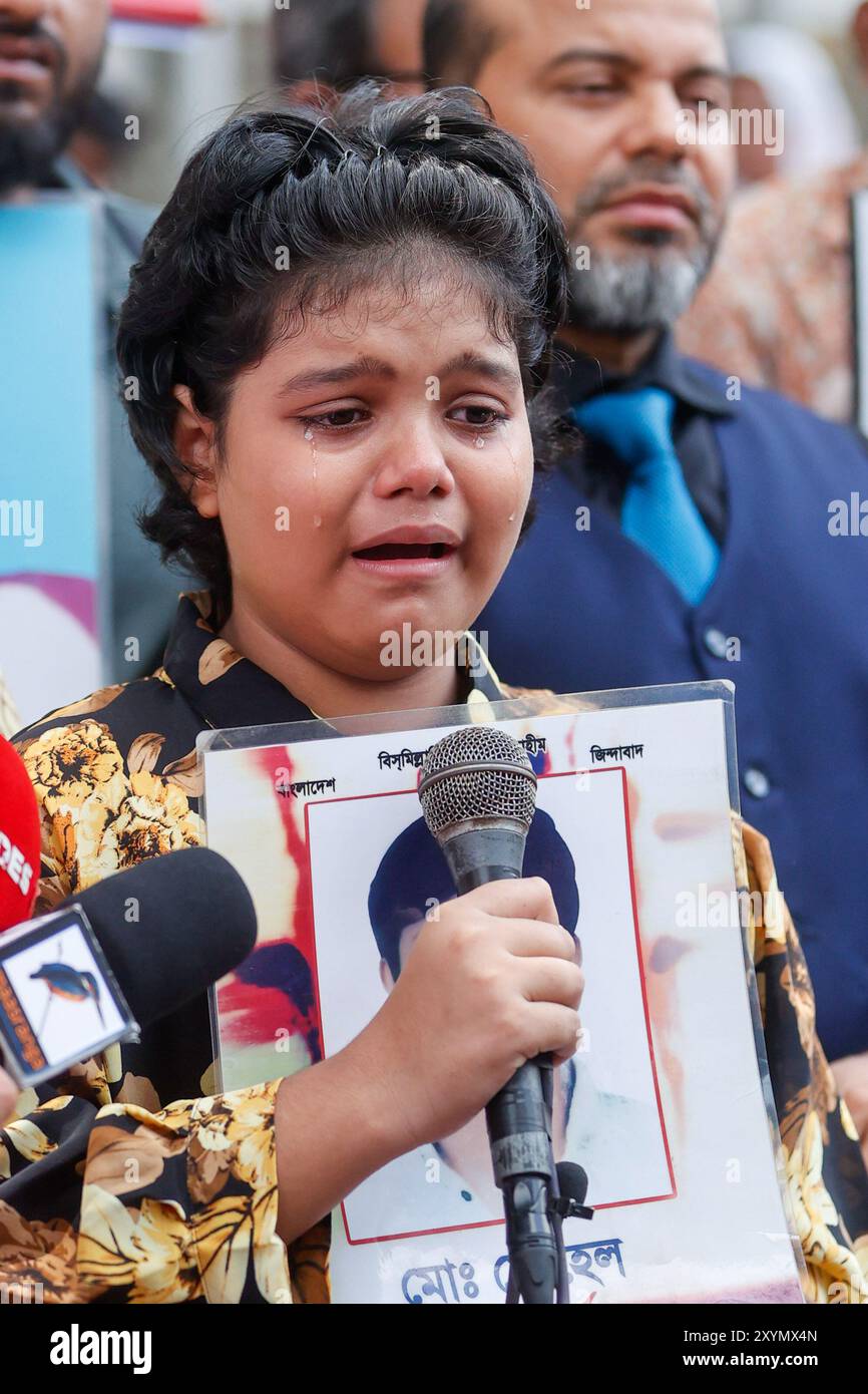 People hold pictures of family members who went missing, during an ...