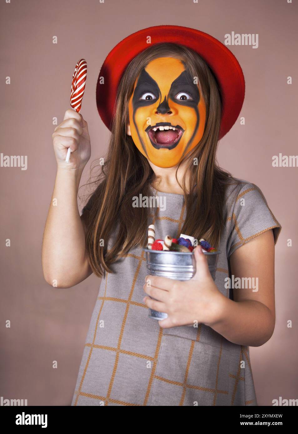 Pretty girl with face painting of a pumpkin. Halloween theme Stock ...