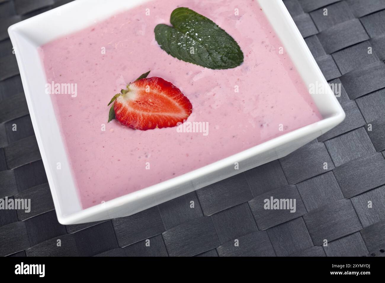 Strawberry curd with a peppermint leaf Stock Photo - Alamy