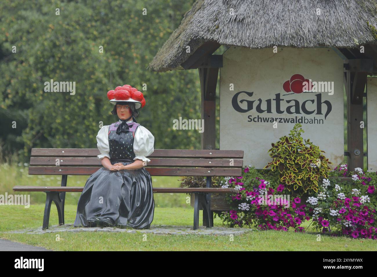 Doll in woman's traditional costume with Bollenhut on bench, Black ...