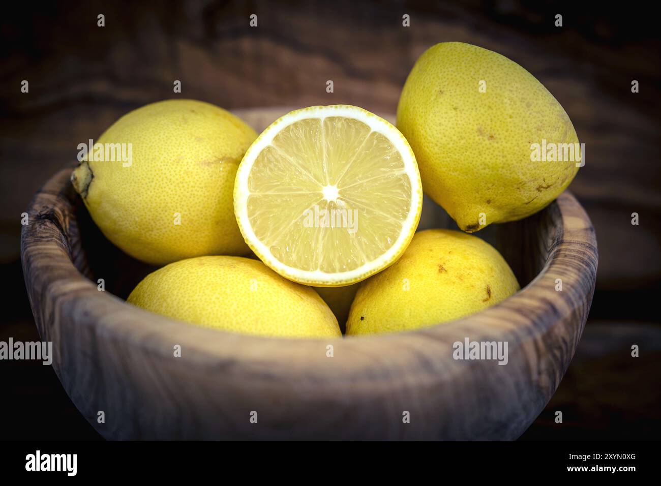 Wooden bowl with lemons Stock Photo - Alamy