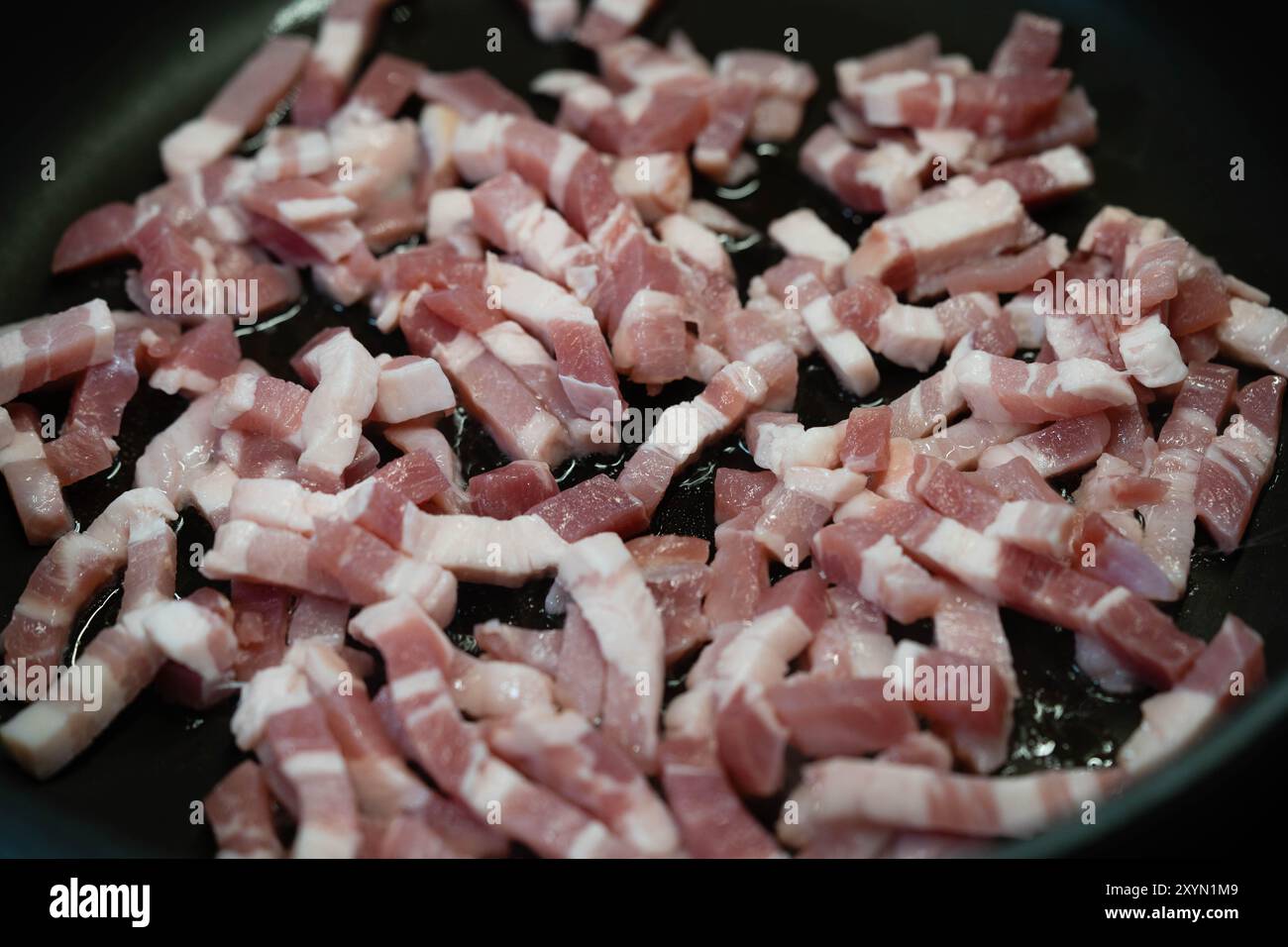 fry the bacon cubes in the pan Stock Photo - Alamy