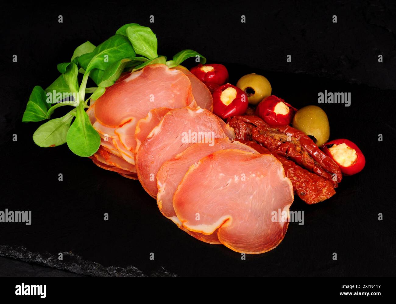 Spanish Lomo air dried pork loin meat slices with olives and cream ...