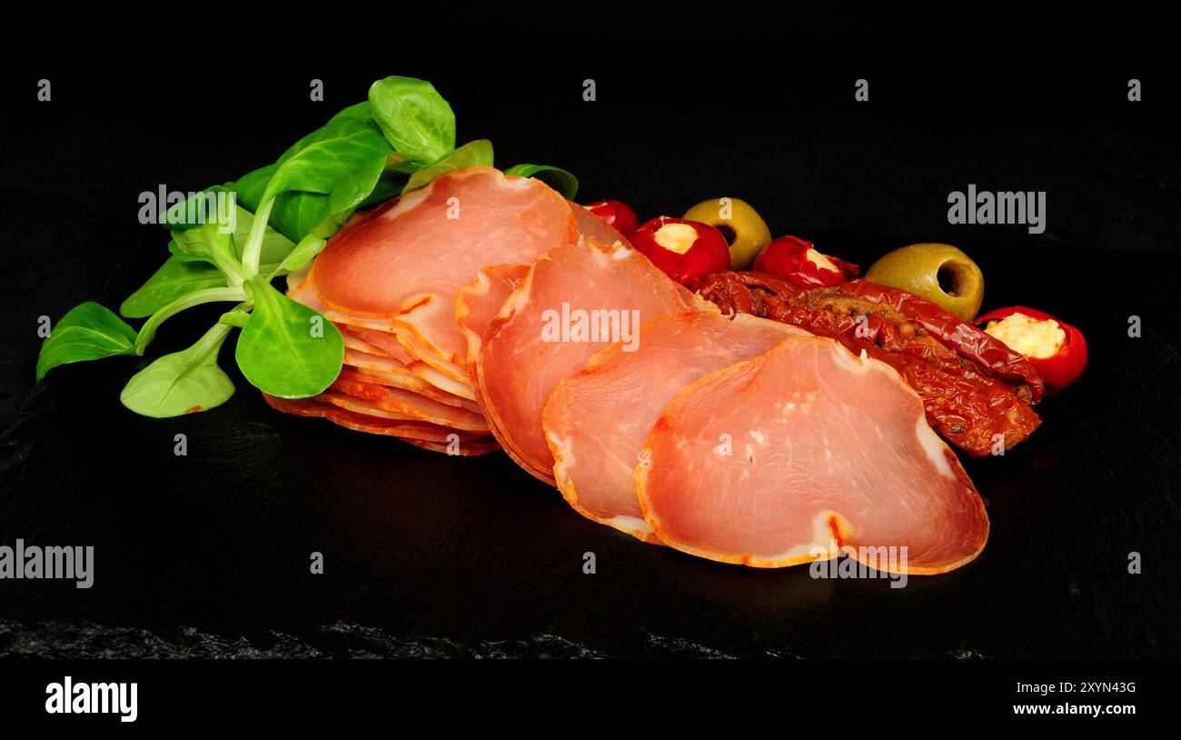 Spanish Lomo air dried pork loin meat slices with olives and cream ...