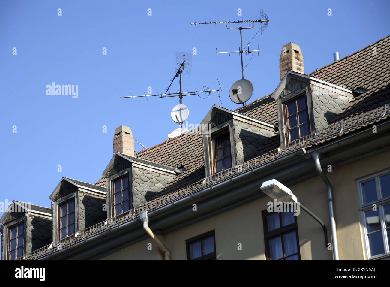 Antennas and SAT dishes on a residential building Stock Photo - Alamy