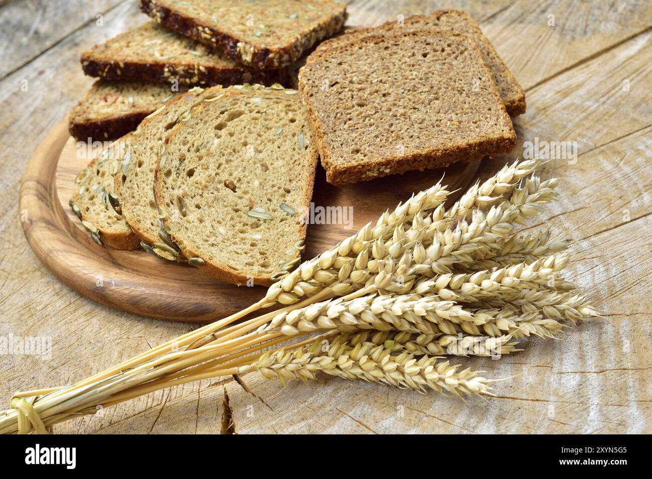 Top view of sliced wholegrain bread on a wooden table. Different types ...