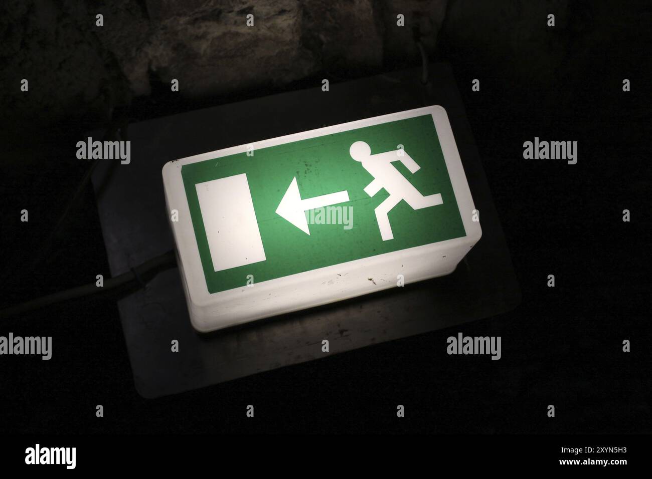 Illuminated emergency exit sign Stock Photo - Alamy