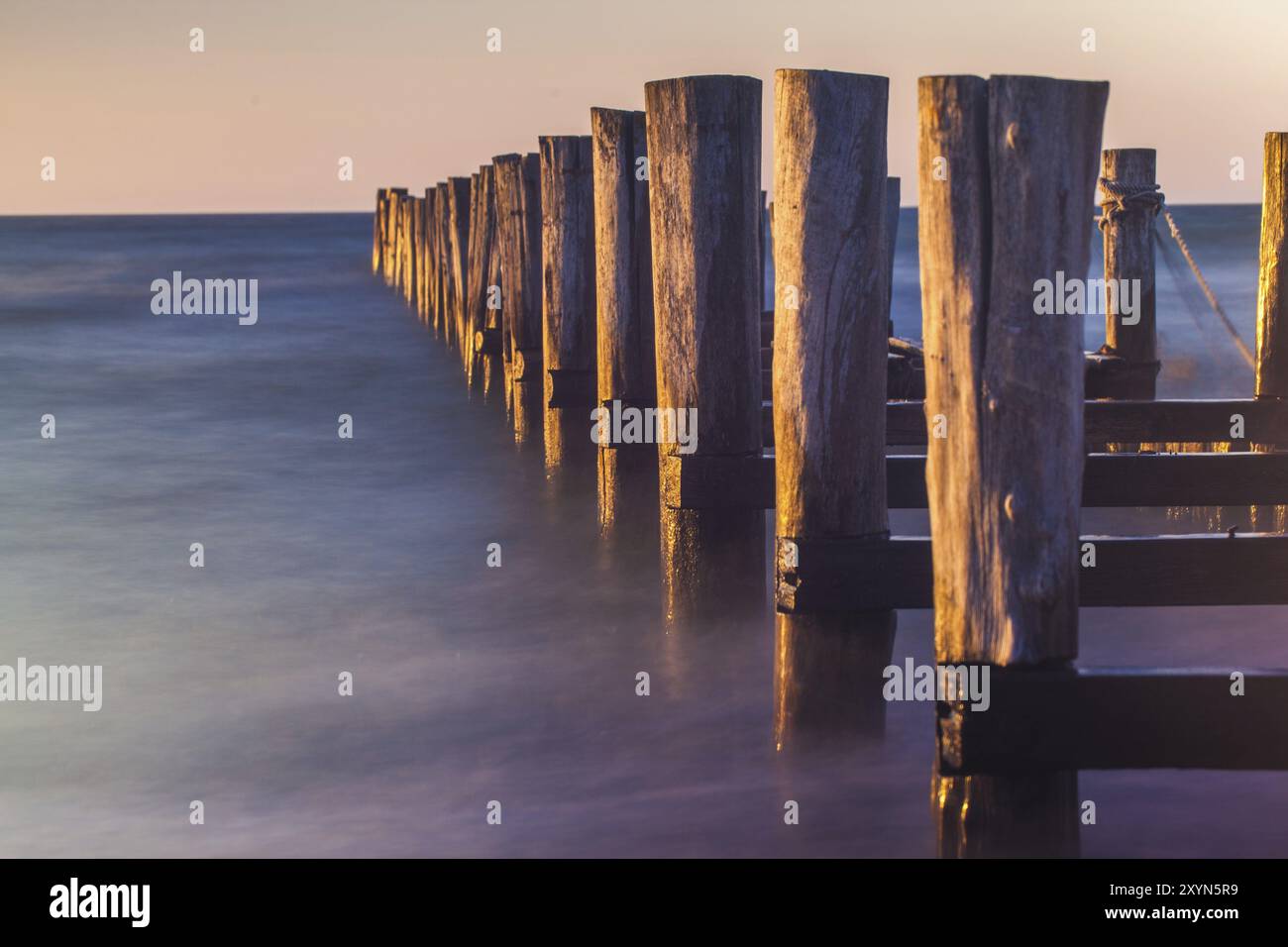 Smooth water around a jetty Stock Photo - Alamy