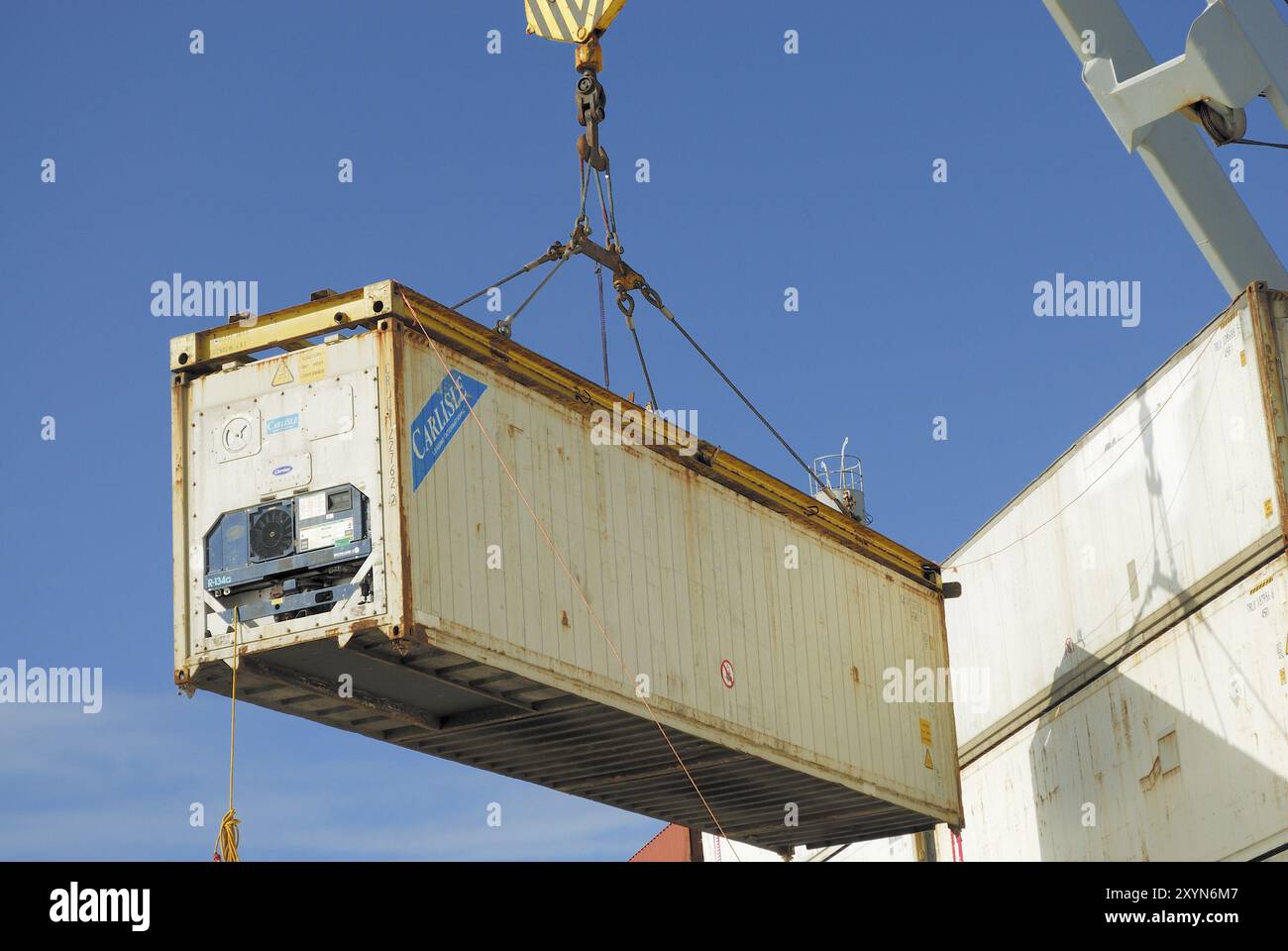 Container unloading with on-board crane Stock Photo - Alamy