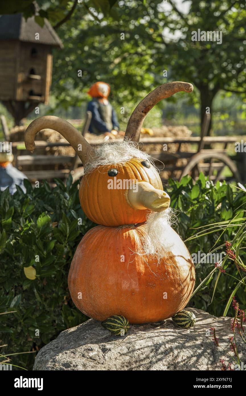 Garden figure made of pumpkins in the shape of an animal with horns and ...