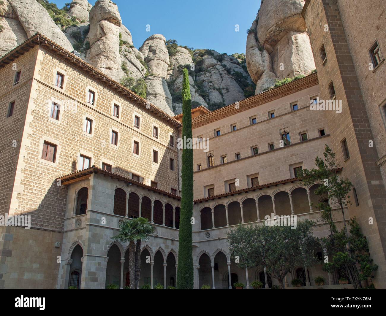 Monastery with an inner courtyard and high rocky mountains in the ...