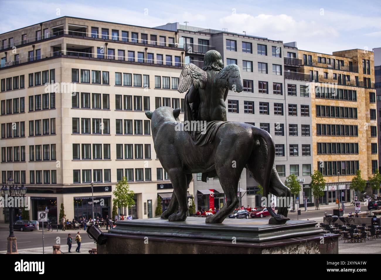 Rear view of a statue of an angel riding a lion, with Berlin buildings ...