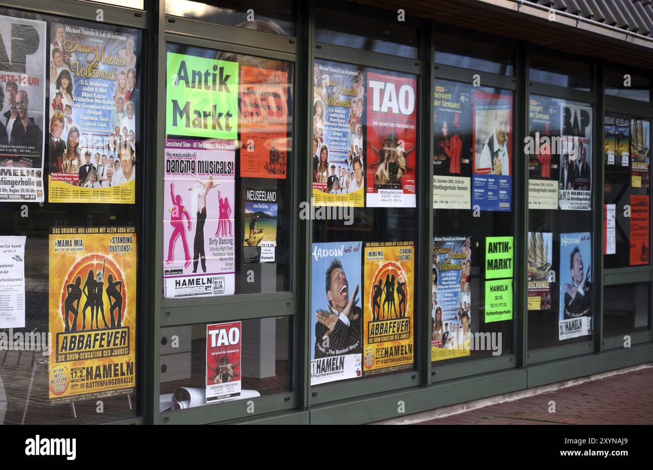 Event posters in the windows of a concert hall Stock Photo - Alamy