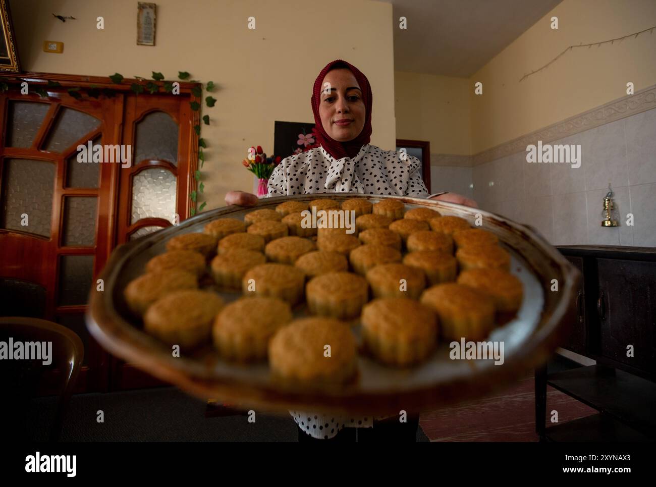 Gaza Strip, Palestine. 01 May 2022: Palestinian women makes sweets ...