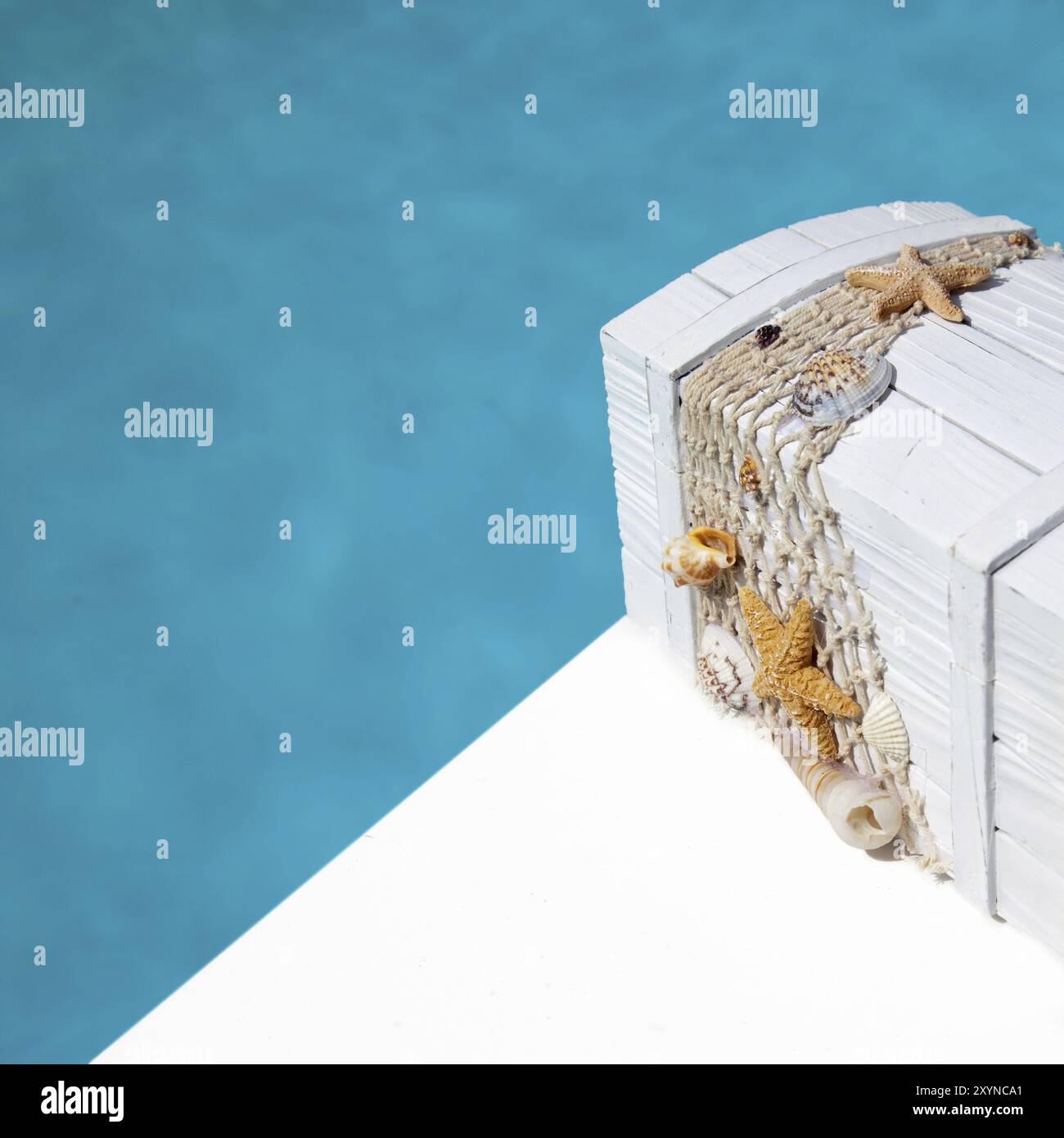 Wooden treasure chest with shells in front of blue water Stock Photo ...