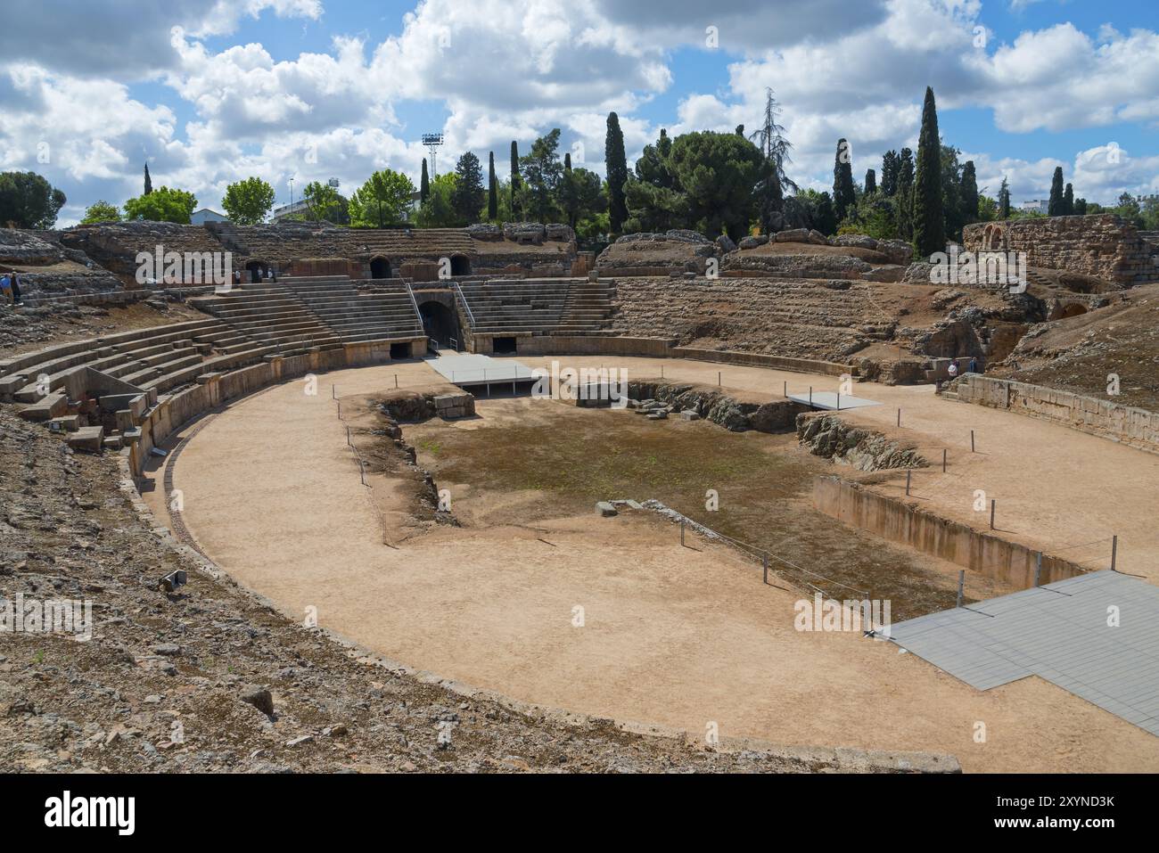 Roman amphitheatre with rows of stone seats and ruins under a clear ...