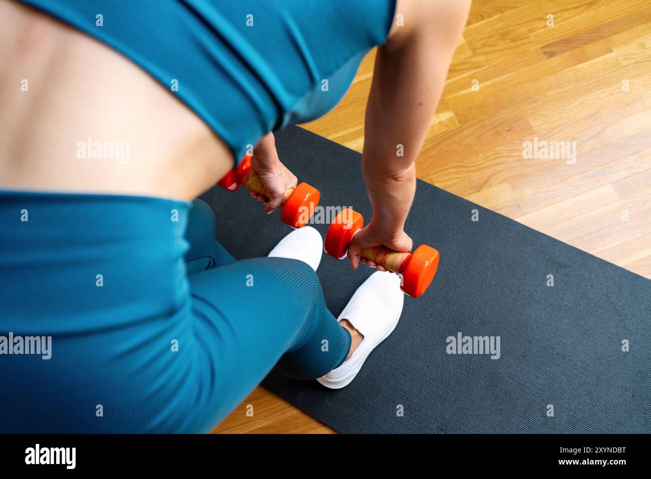 Athletic woman using dumbbells during workout Stock Photo - Alamy
