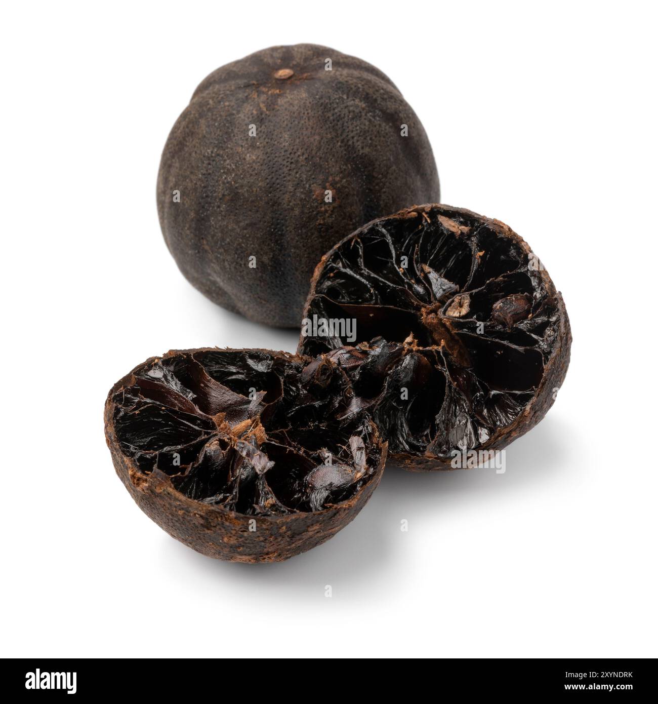 Whole and halved dried black limes, loomi, isolated on white background ...