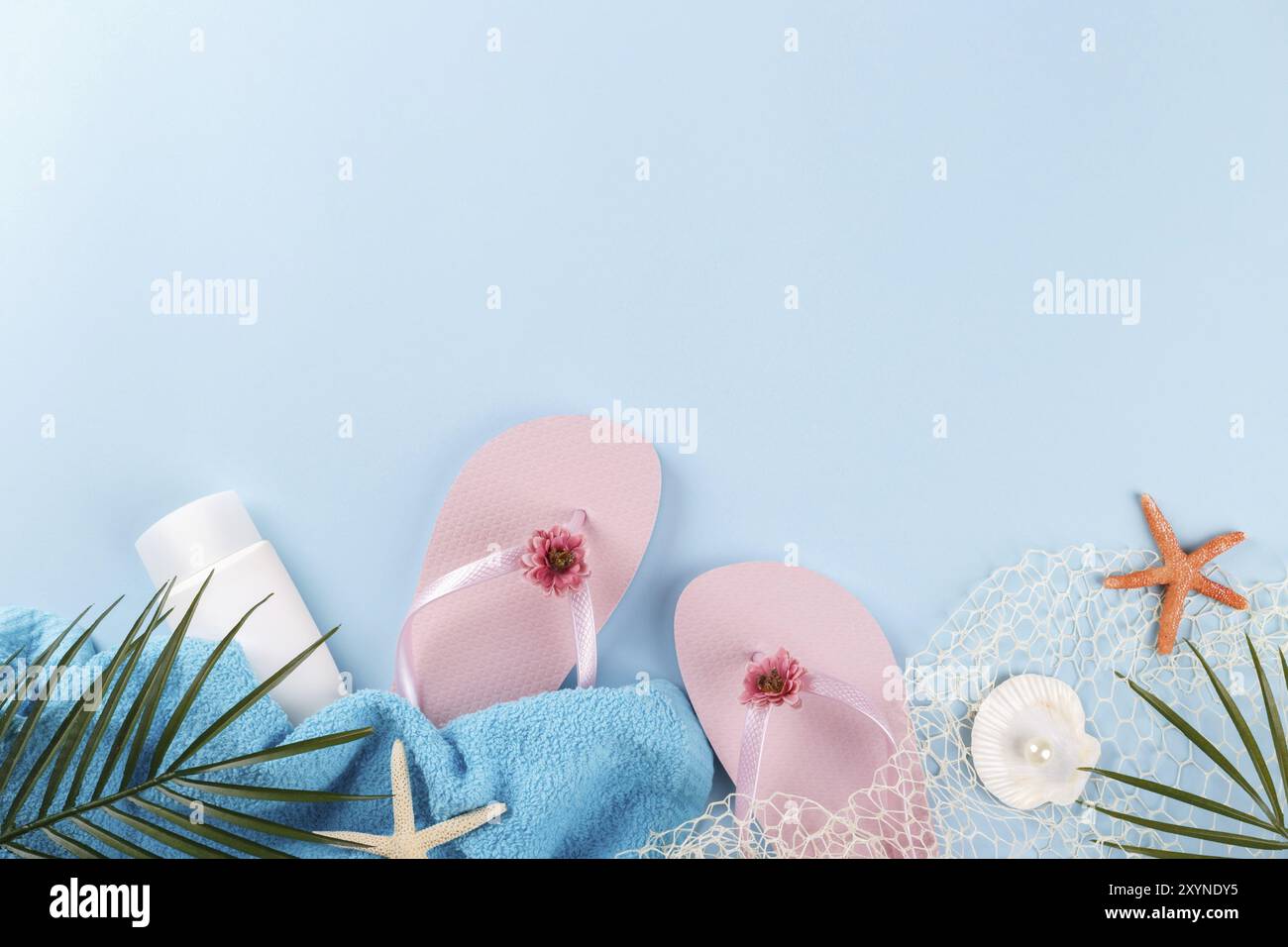 Summer holidays, pink beach slippers flip flops, towel, palm tree ...