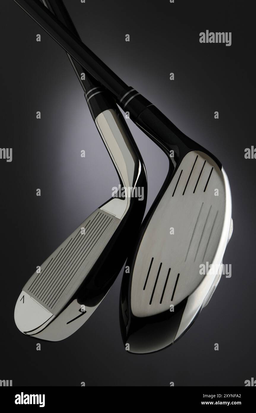 Closeup of a Golf Driver and seven iron over a dark background with ...