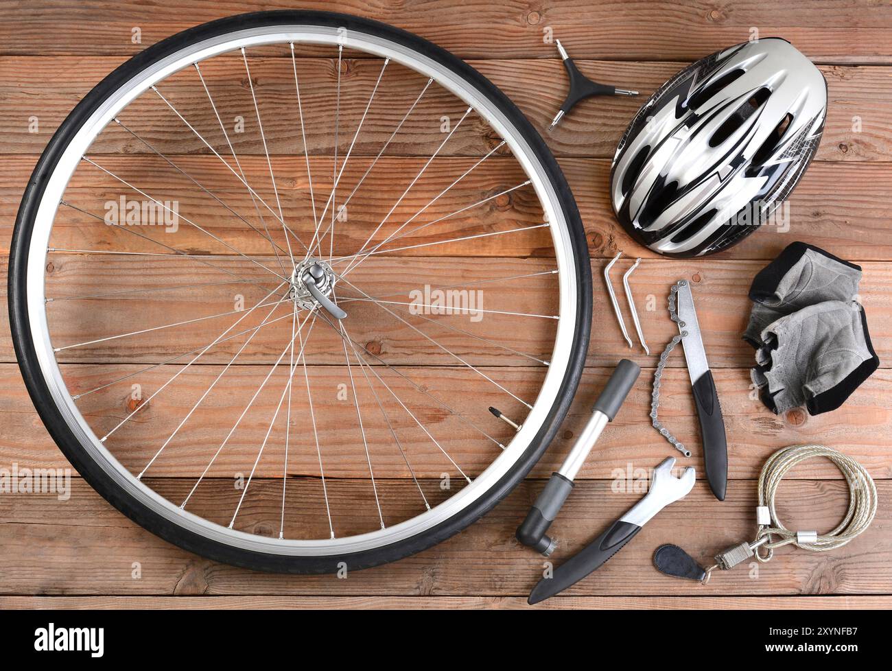 Overhead view of bicycle gear laid out on a rustic wooden floor. Items ...