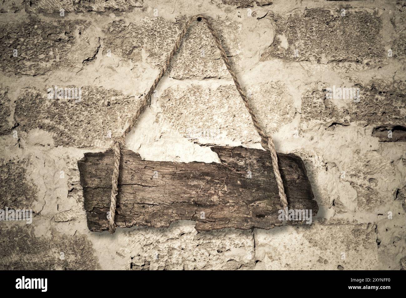 Old wooden sign hanging on a stone wall Stock Photo - Alamy