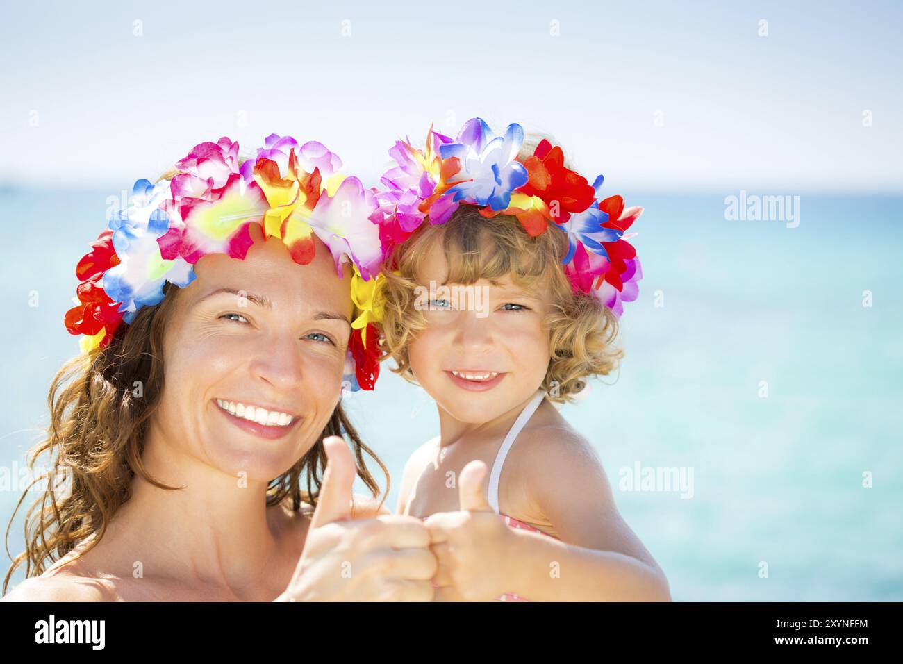 Happy family showing thumb up sign against blue sea background. Summer ...