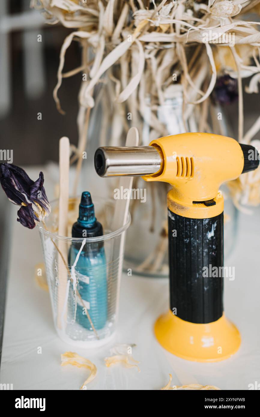 Close-up of heat gun and resin art supplies in a home studio ...