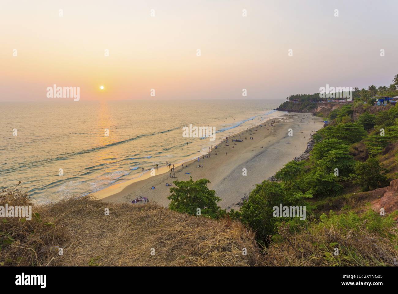 High angle view of beach and ocean during evening sunset as sun ...