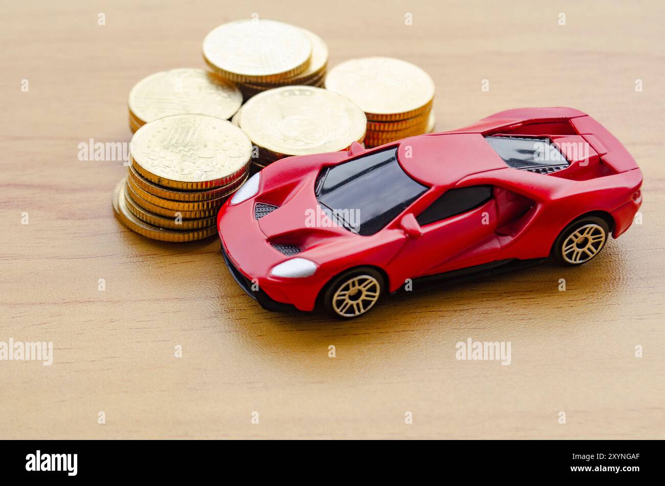 Side angle view of toy car with gold coins. Business and wealth concept ...