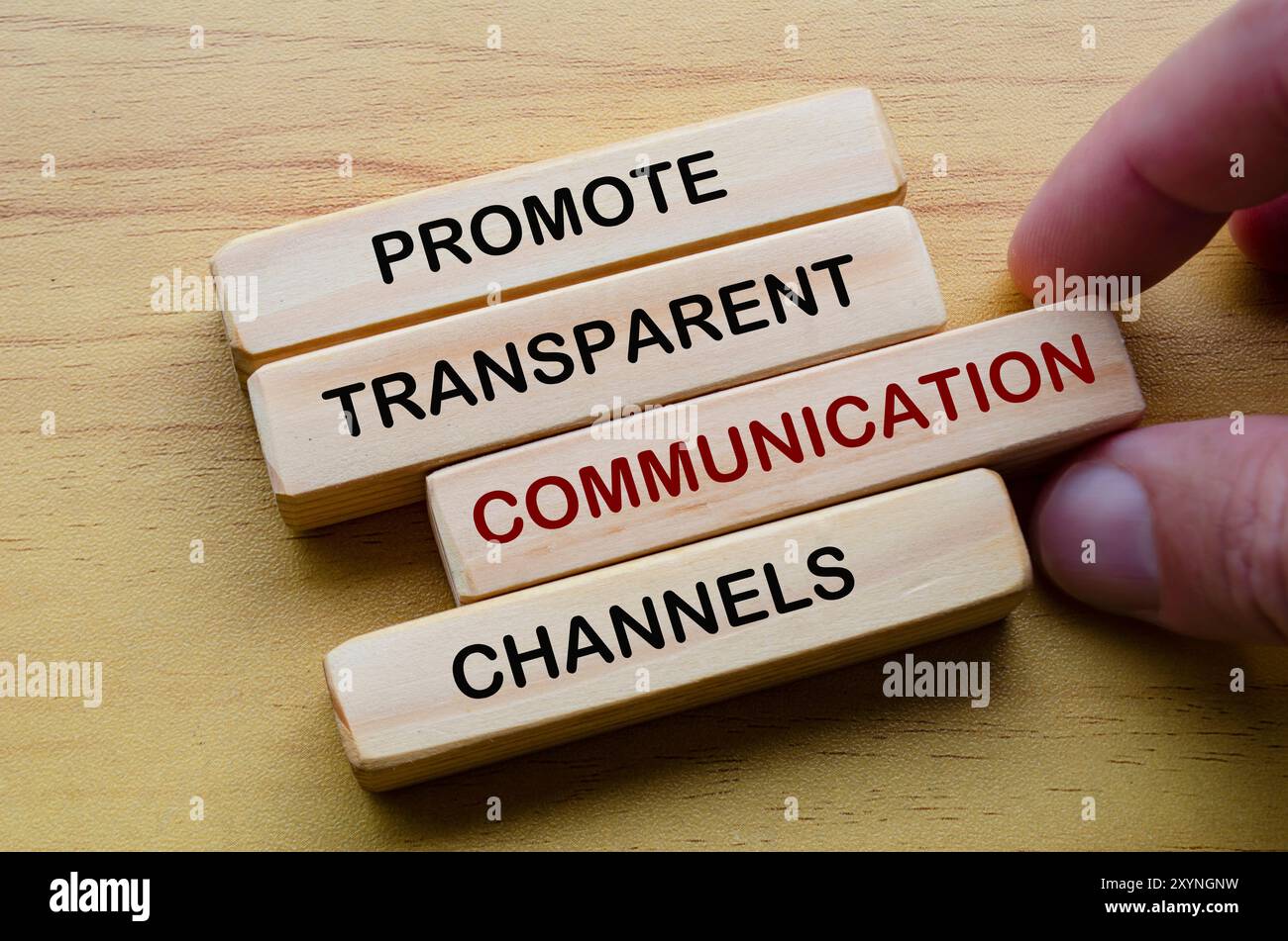 Promote transparent communication channels text on wood block with hand ...