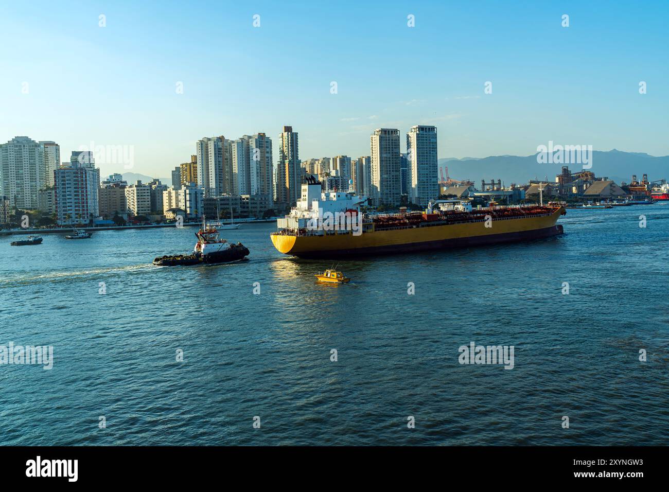 Cargo ship entering a city Stock Photo - Alamy