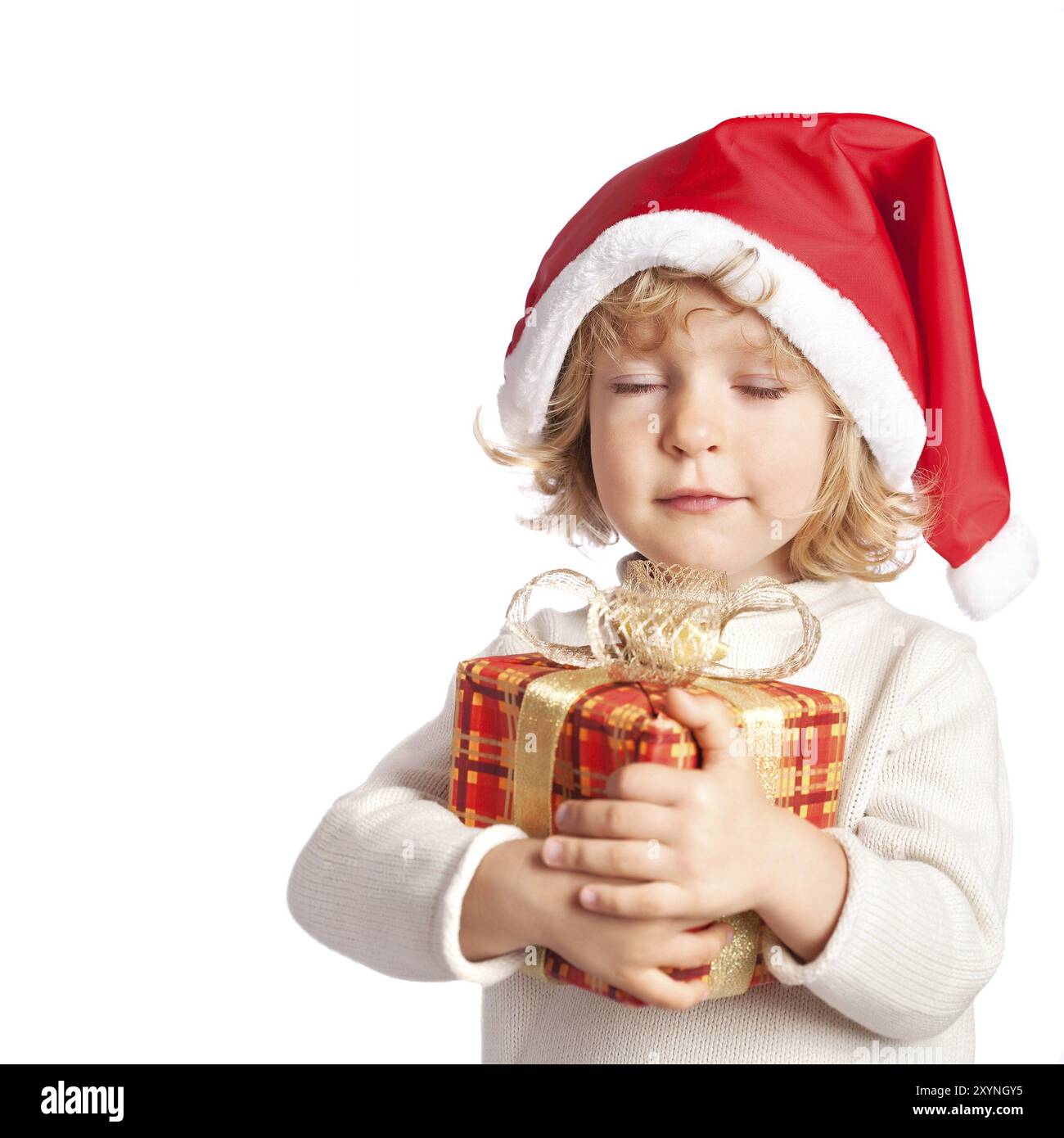 Beautiful baby making a wish with Christmas gift box. Isolated on white ...