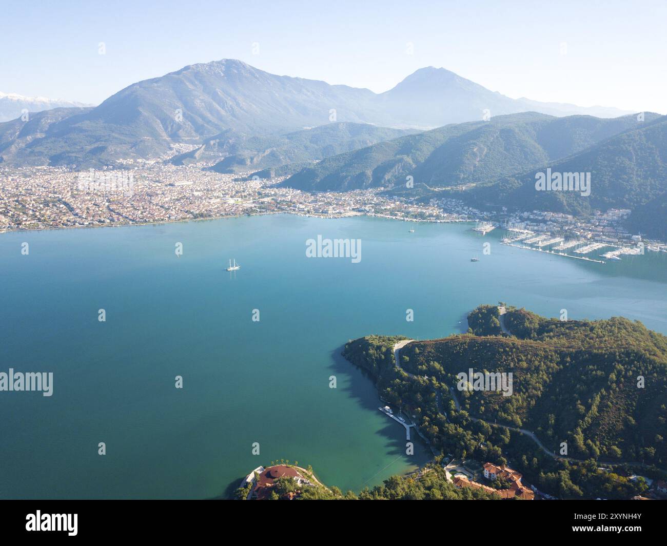 Drone aerial view of Mediterranean Sea, mountains behind coastal city ...