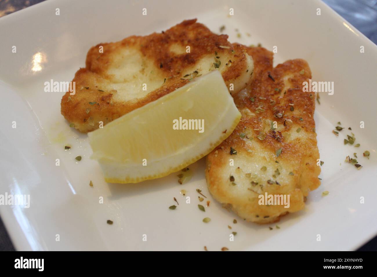 Greek cuisine: saganaki (Greek fried cheese) with lemon Stock Photo - Alamy