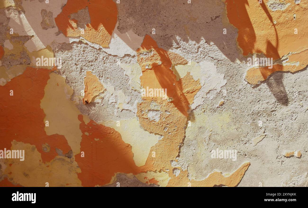 Background with crumbling orange and white wall Stock Photo - Alamy