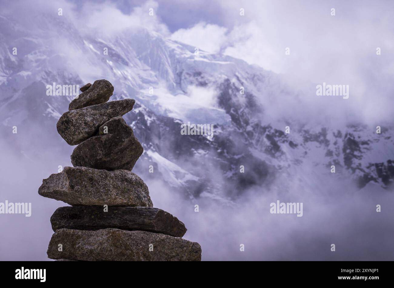 Cusco, Peru in October 2015: A stack of rocks in front of a snow topped ...