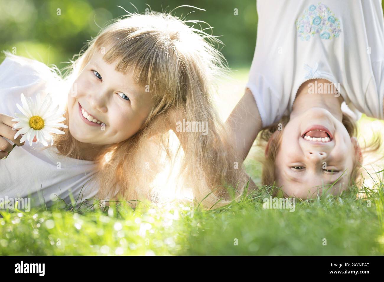 Happy children playing outdoors in spring park Stock Photo - Alamy