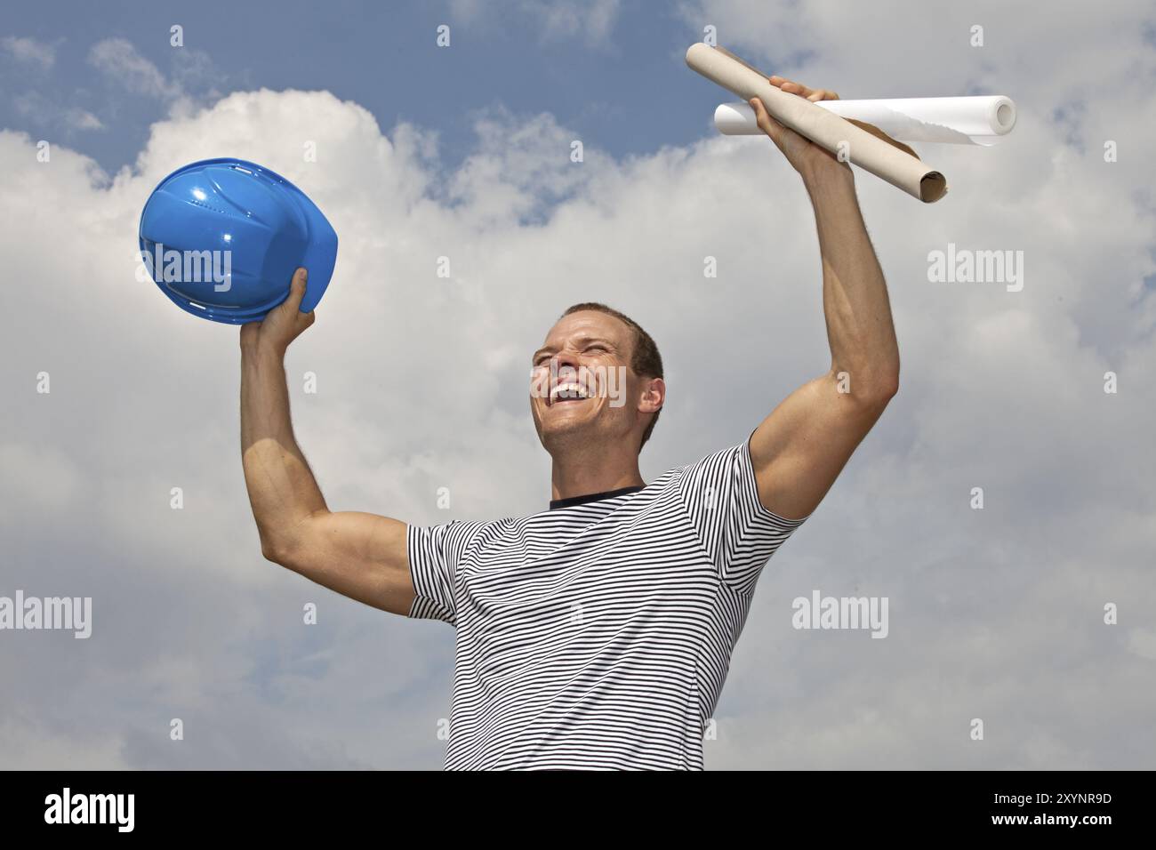Smiling young architect holding a hard hat and blueprints Stock Photo ... Smiling young architect holding a hard hat and blueprints Stock Photo ...